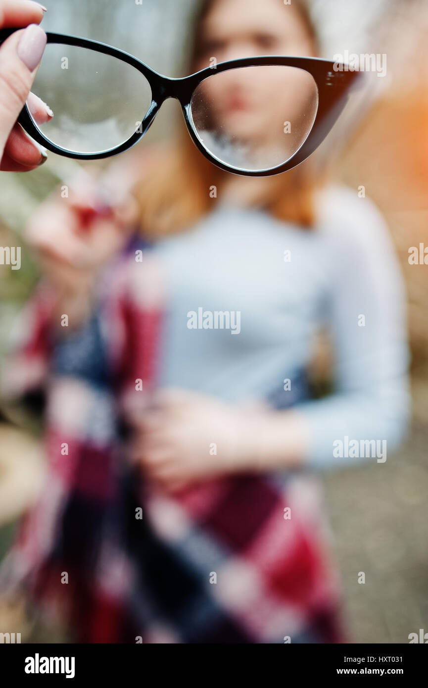 Girl gives her friend glasses, soft focus. Bad eye vision of people ...