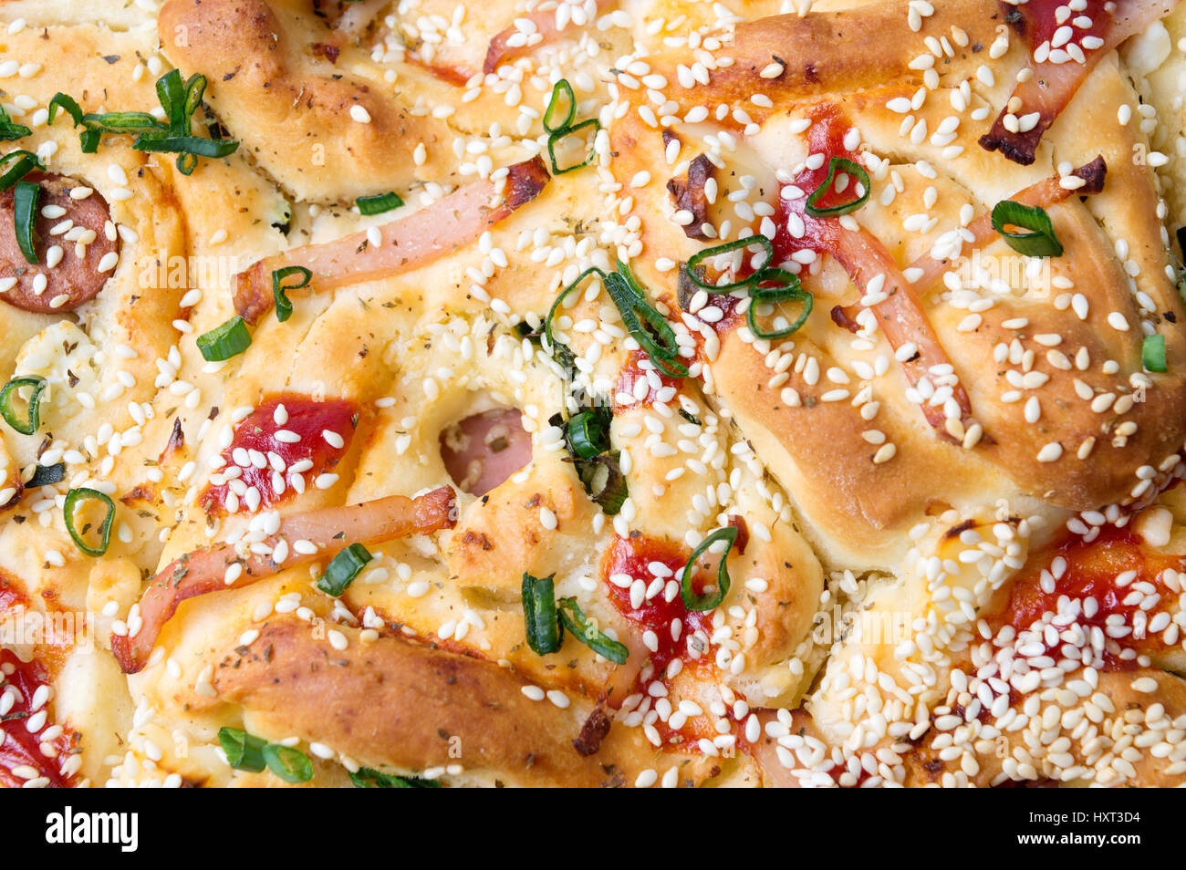 Pizza bread with sesame, onions and ham Stock Photo - Alamy