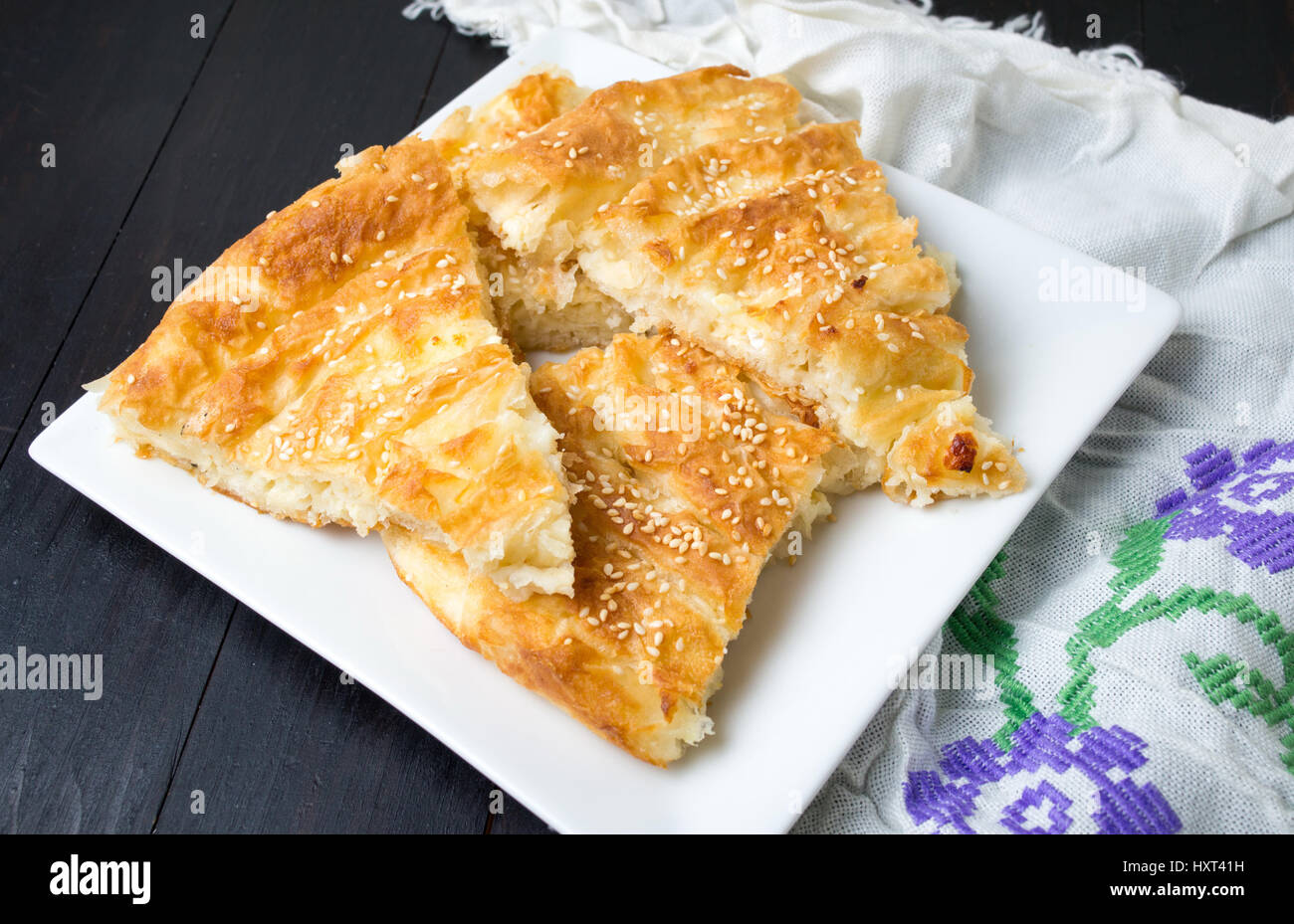 Cheese pie covered with sesame on a plate Stock Photo - Alamy