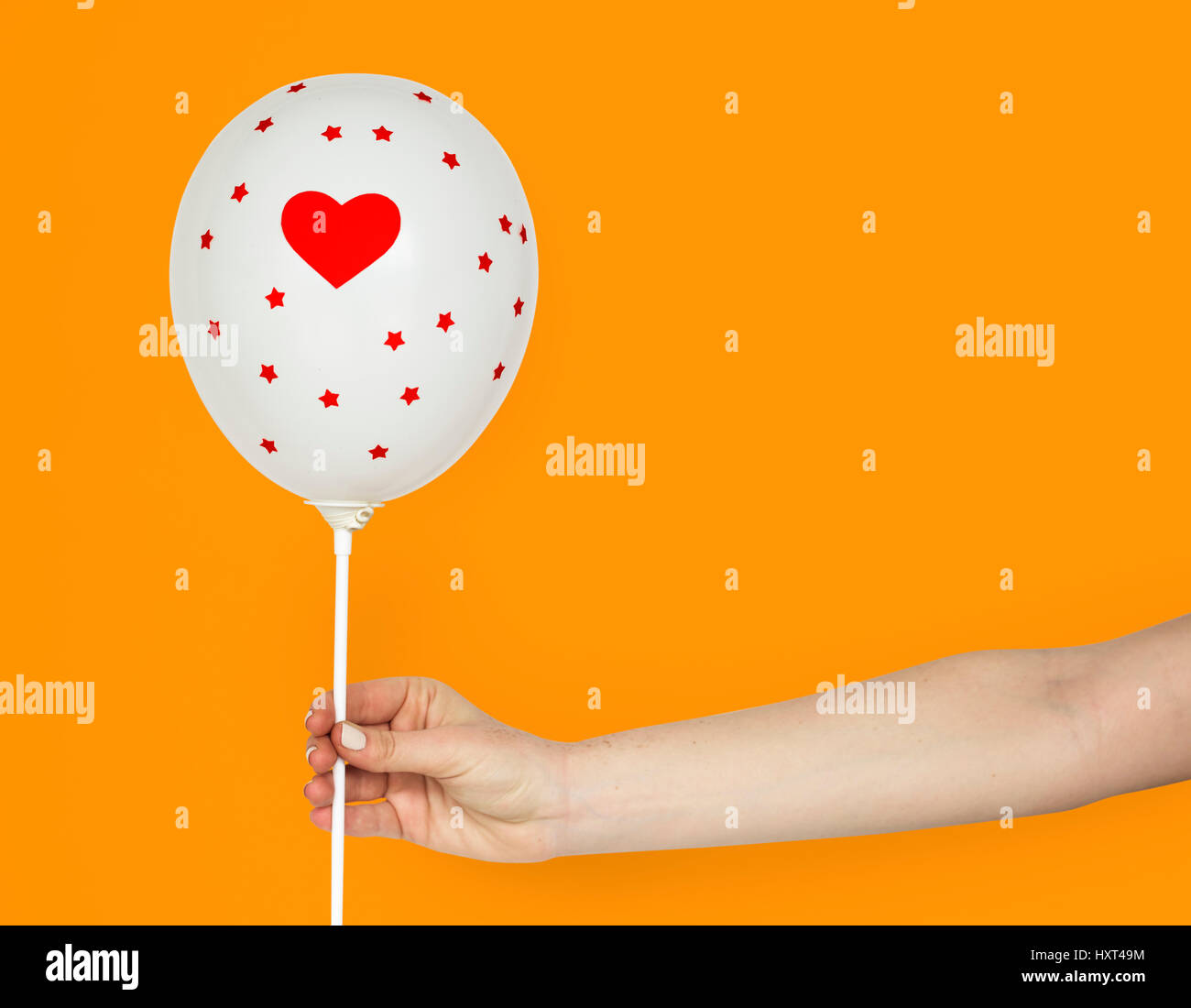 Hands holding balloon hi-res stock photography and images - Alamy