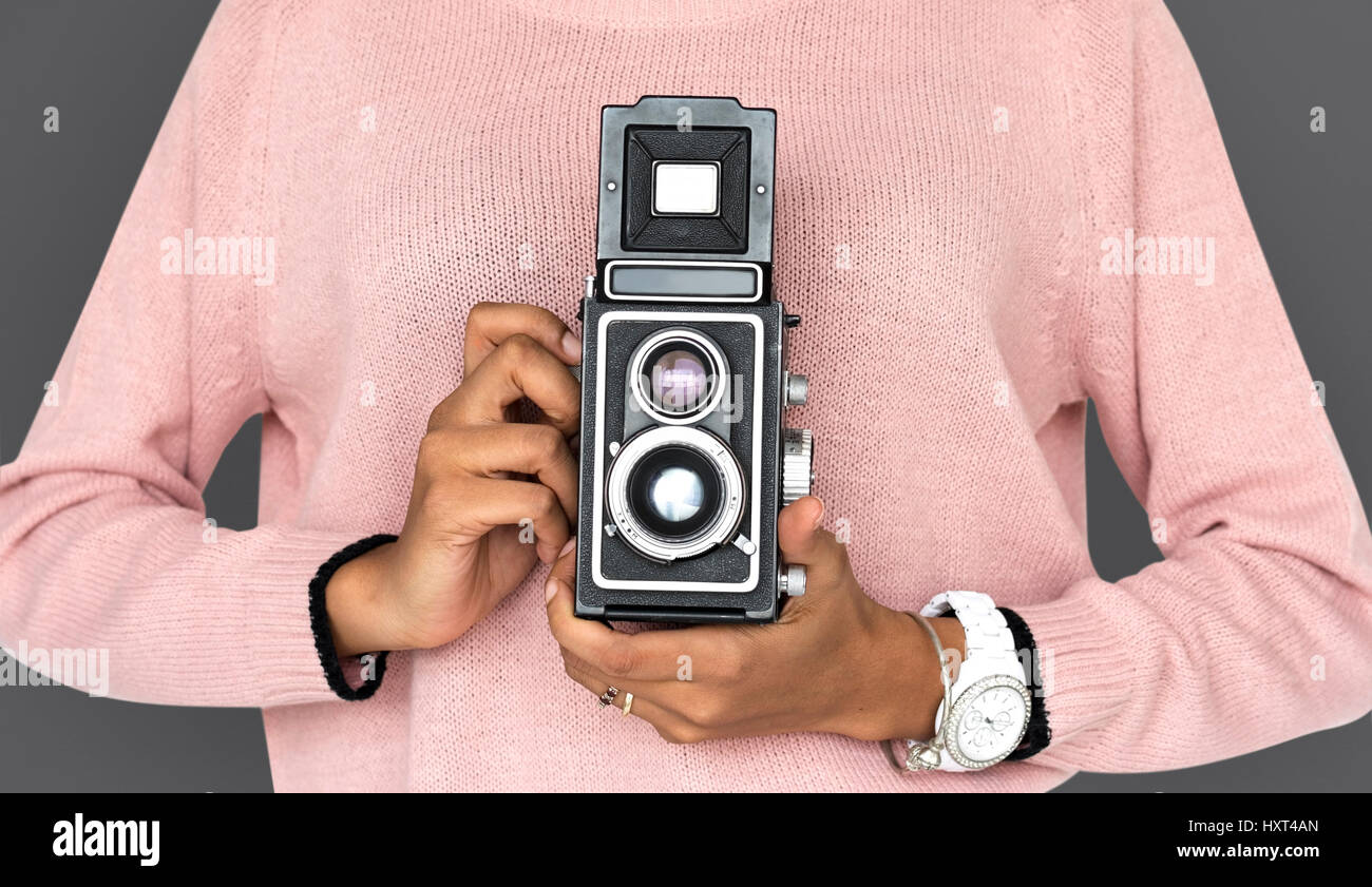 Girl Holding retro classic camera Stock Photo - Alamy