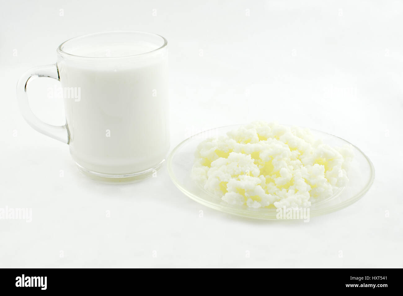 Glass of kefir and kefir grains on white background Stock Photo - Alamy