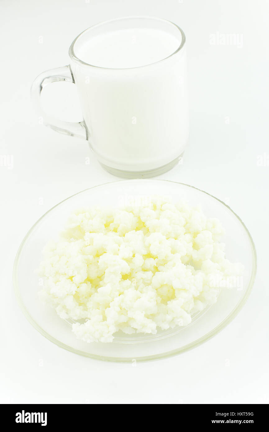 Glass of kefir and kefir grains on white background Stock Photo - Alamy