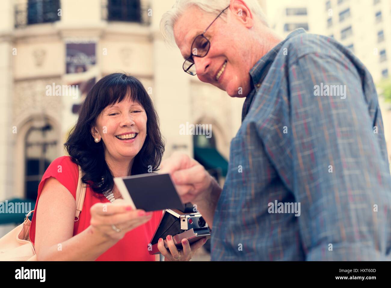 Couple checking instant camera image Stock Photo - Alamy