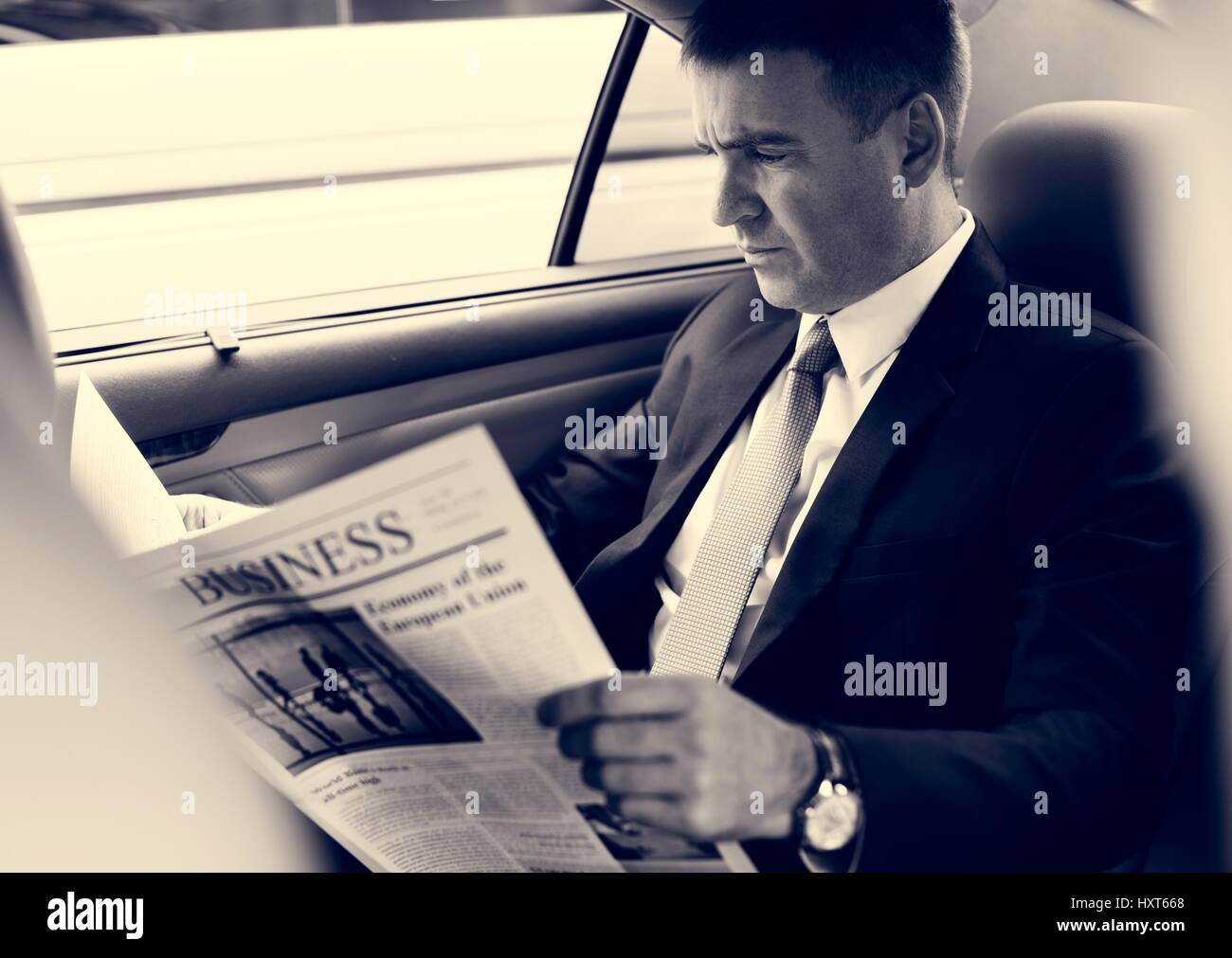 Businessman Reading Newspaper Car Inside Stock Photo - Alamy