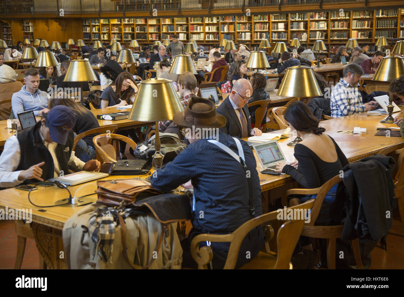 People use the large iconic south reading room at the New York Public ...