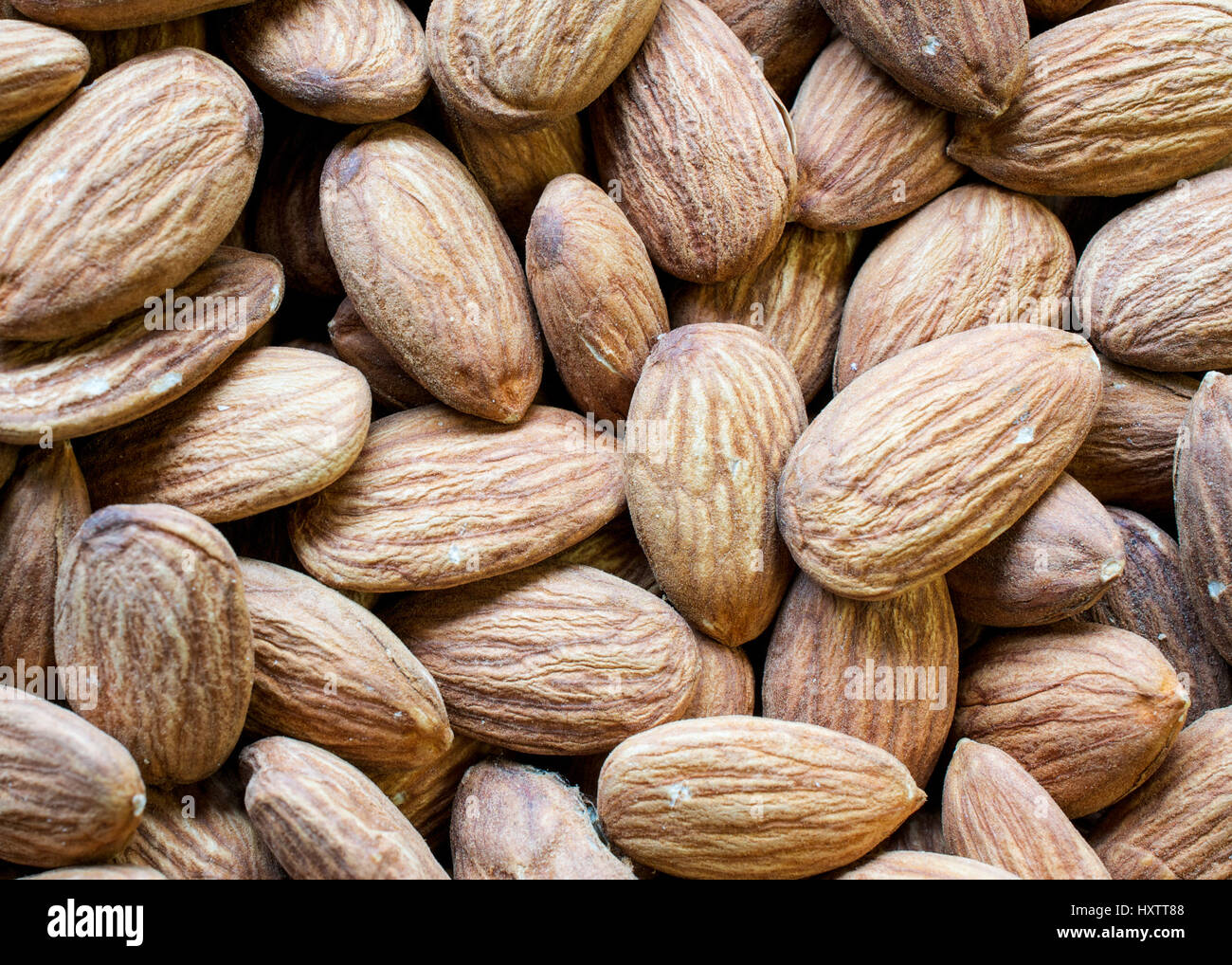 Closeup on dry roasted almonds- food texture or background Stock Photo ...