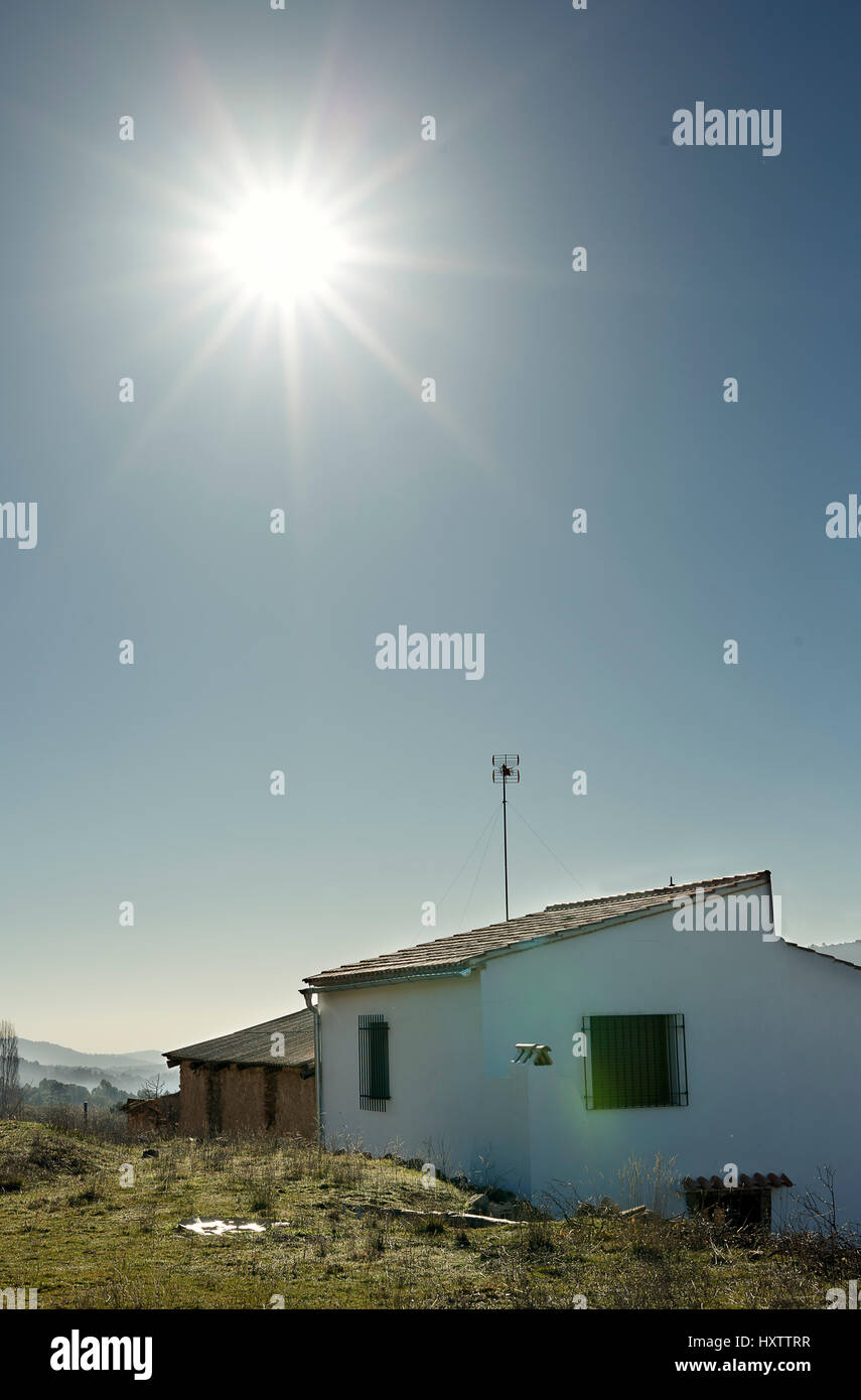 Landscape of a Spanish village with the sun in the frame. Vertical shot ...