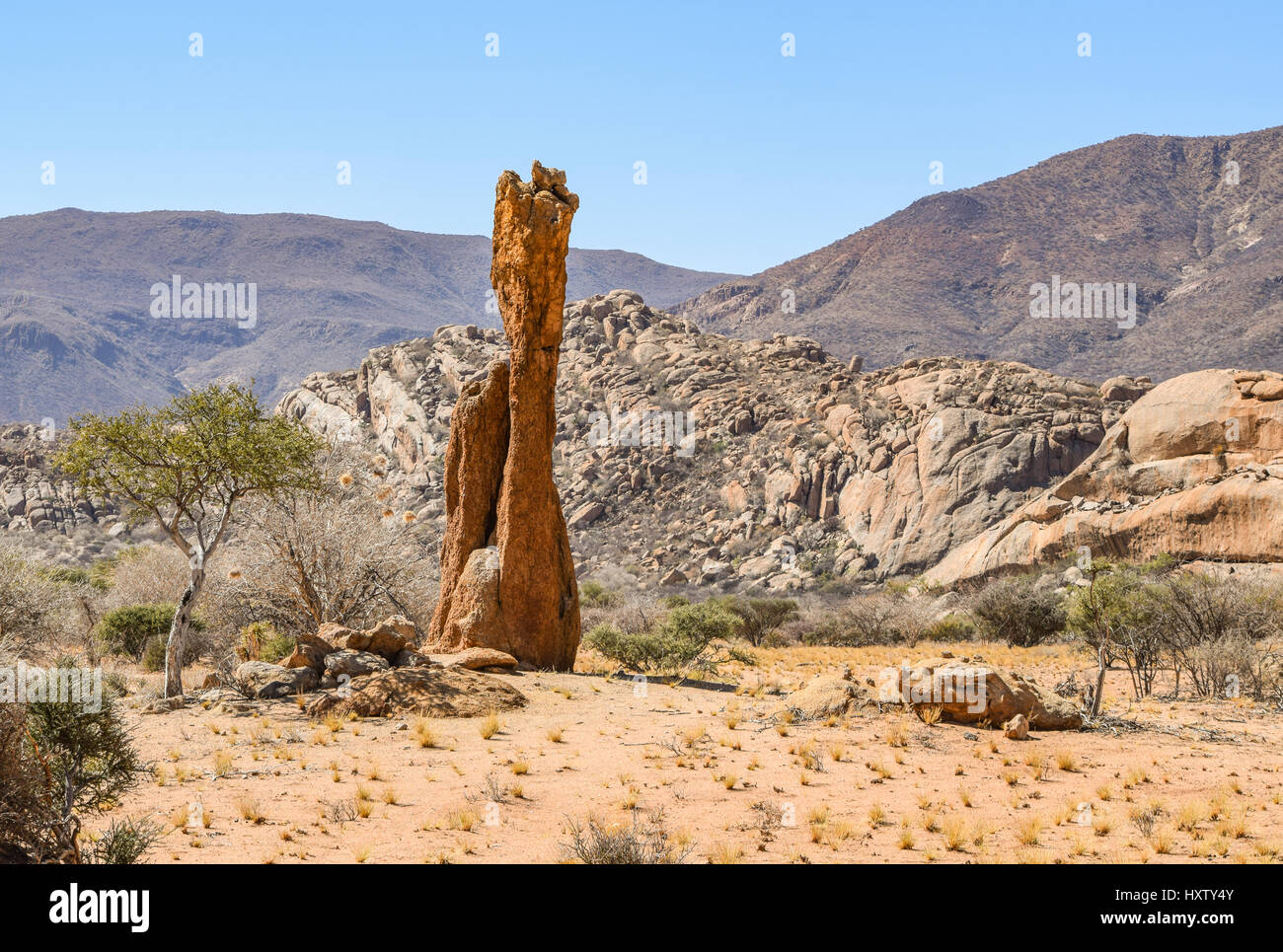 sunny illuminated landscape including a rock formation seen in Namibia ...