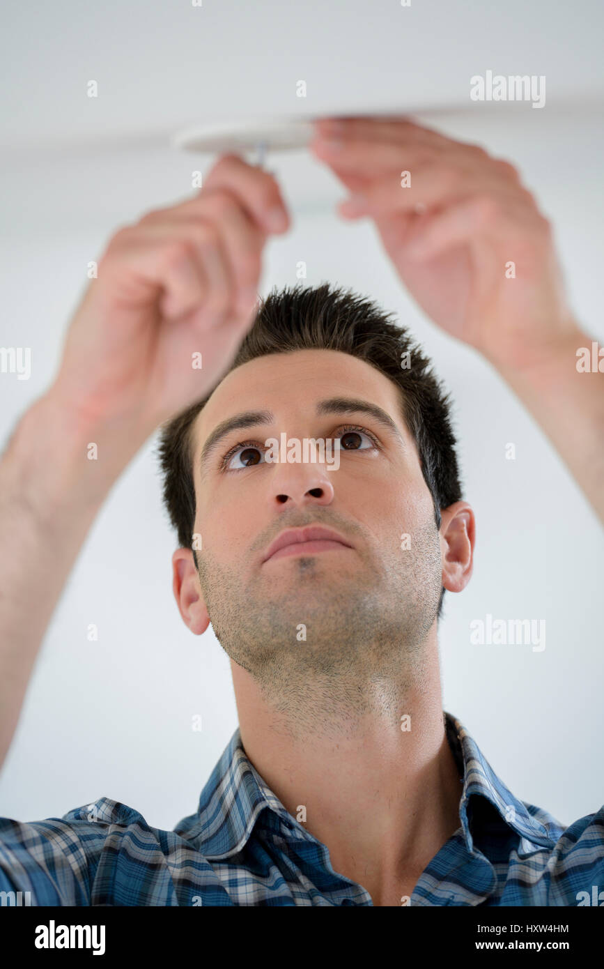 Worker checking a device Stock Photo - Alamy