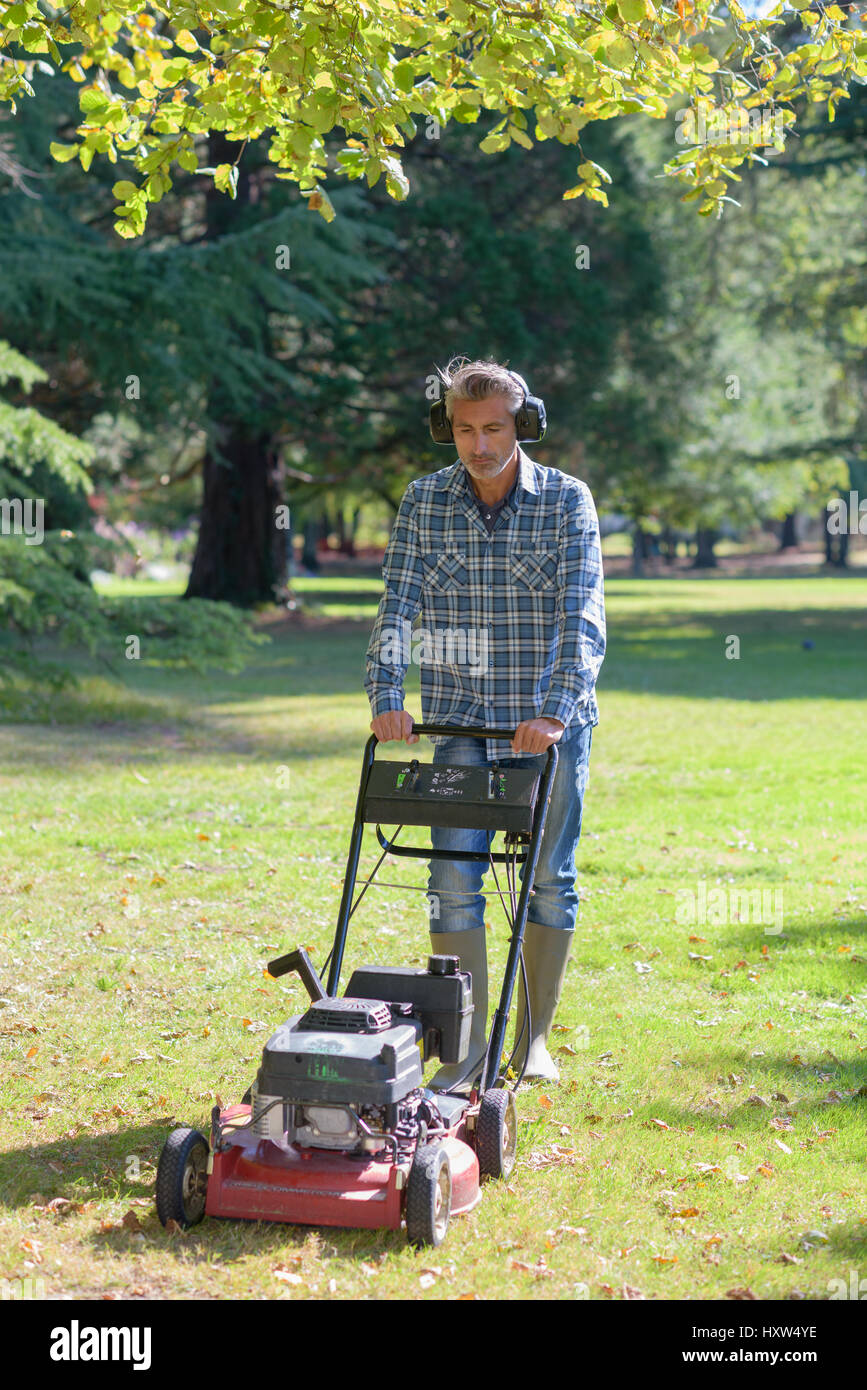 Man mowing grass Stock Photo - Alamy