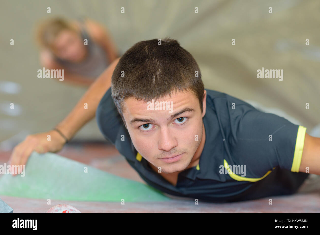 Downward view of man on climbing wall Stock Photo - Alamy