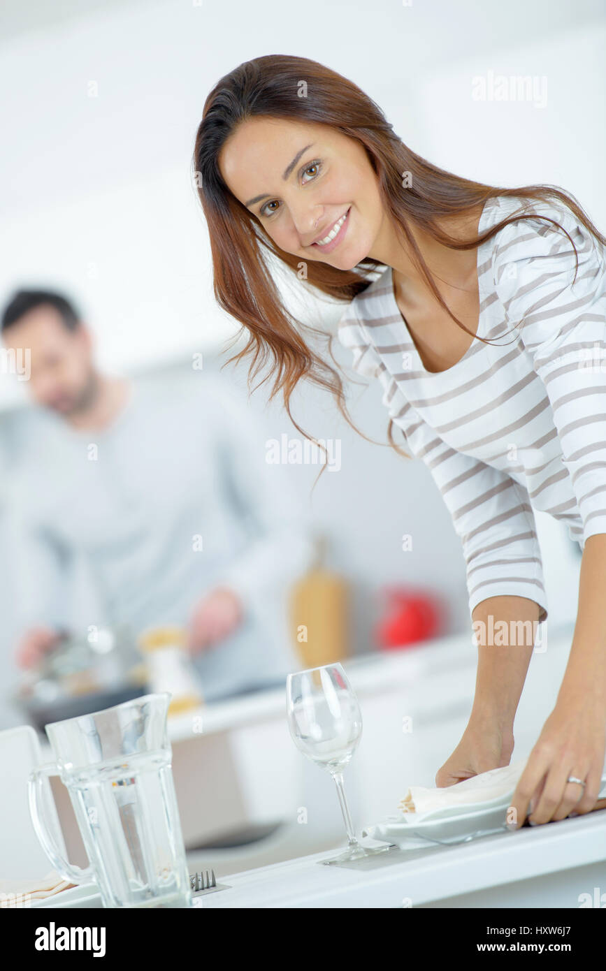Woman setting the dining table Stock Photo - Alamy