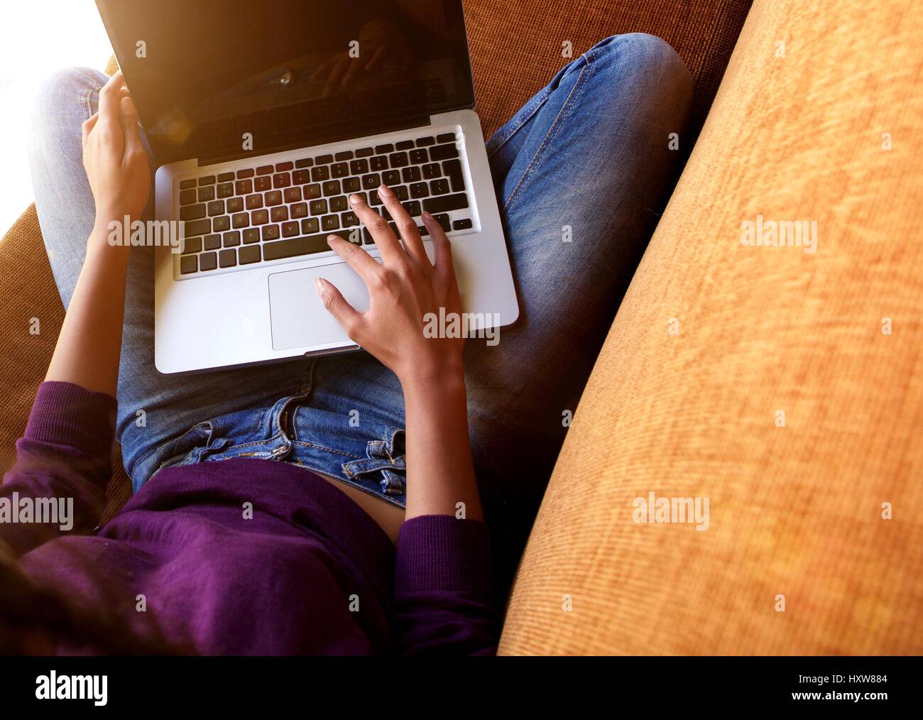 Portrait from above woman sitting on sofa with laptop Stock Photo - Alamy