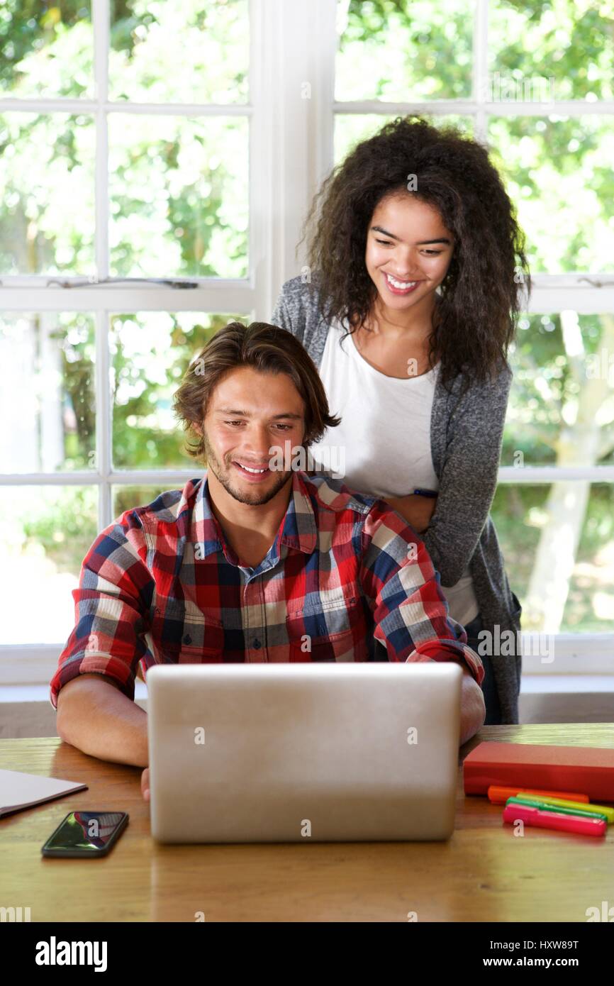 Portrait of two people working from home on laptop Stock Photo - Alamy