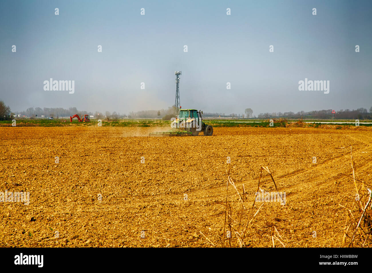 Tractor working in the fields, horizontal hdr image Stock Photo - Alamy