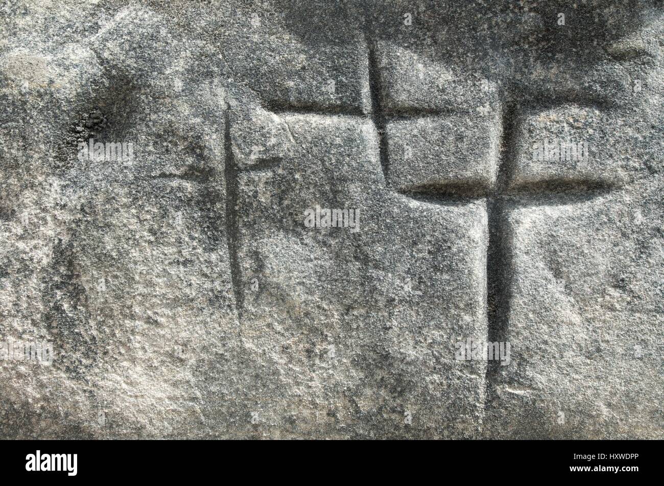 close-up of a cross engraved on a rock wall Stock Photo - Alamy
