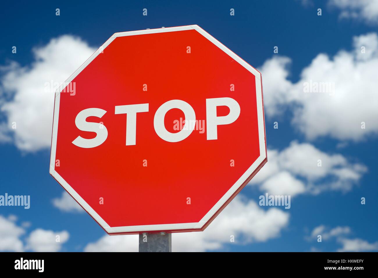 Stop sign and blue sky with white clouds Stock Photo - Alamy