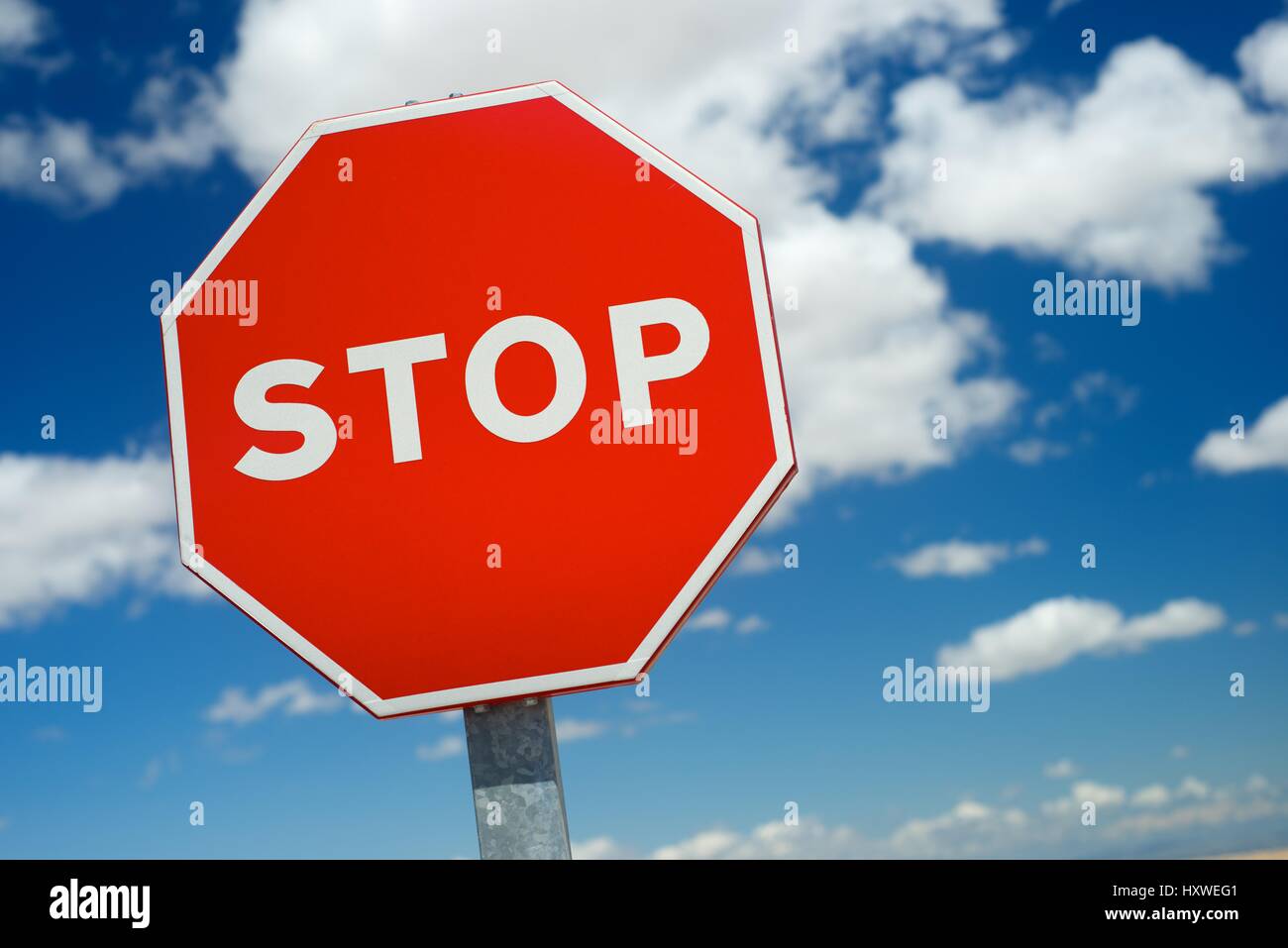 Stop sign and blue sky with white clouds Stock Photo - Alamy
