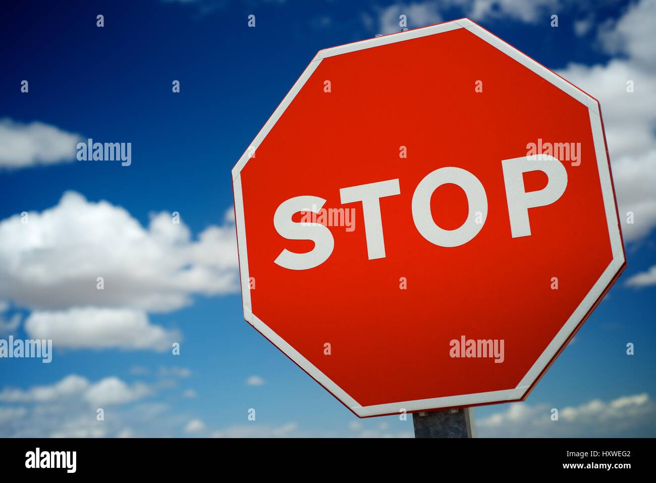 Stop sign and blue sky with white clouds Stock Photo - Alamy
