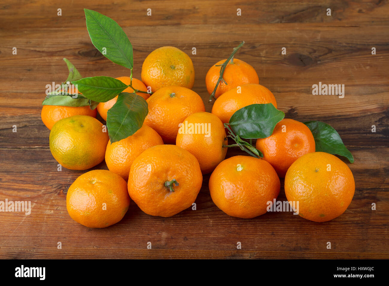 Tangerines on old wooden rustic background Stock Photo - Alamy