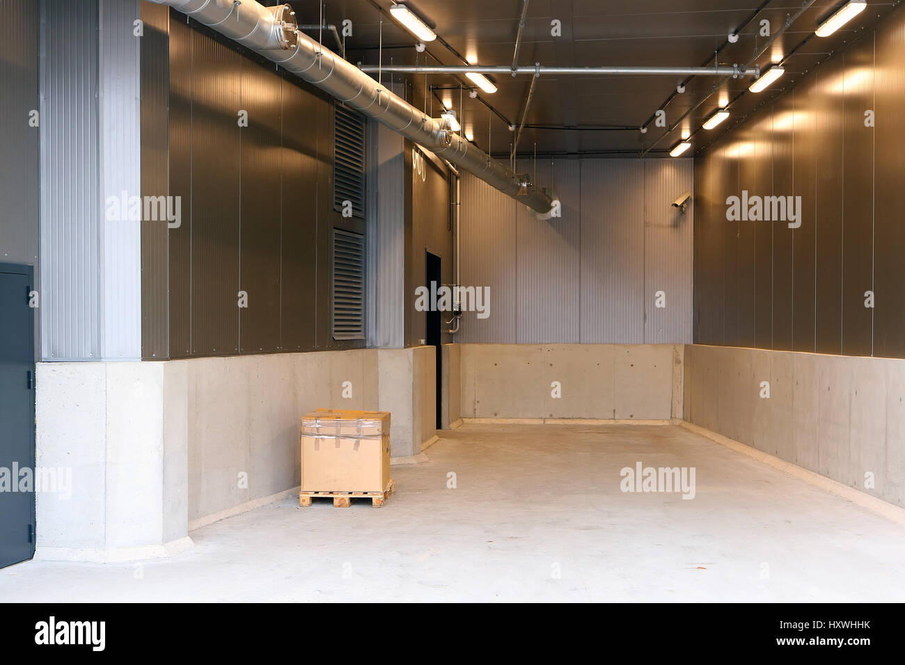 The empty storage room of warehouse has walls of stainless steel and ...