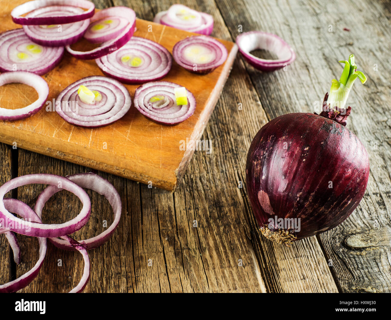 Sliced blue onion on an old weathered wooden table Stock Photo - Alamy