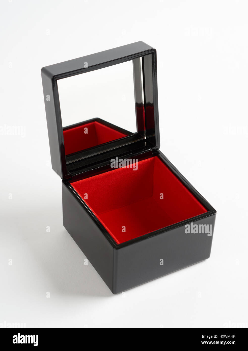 Black plastic glossy gift box with mirror and red bottom isolated on ...