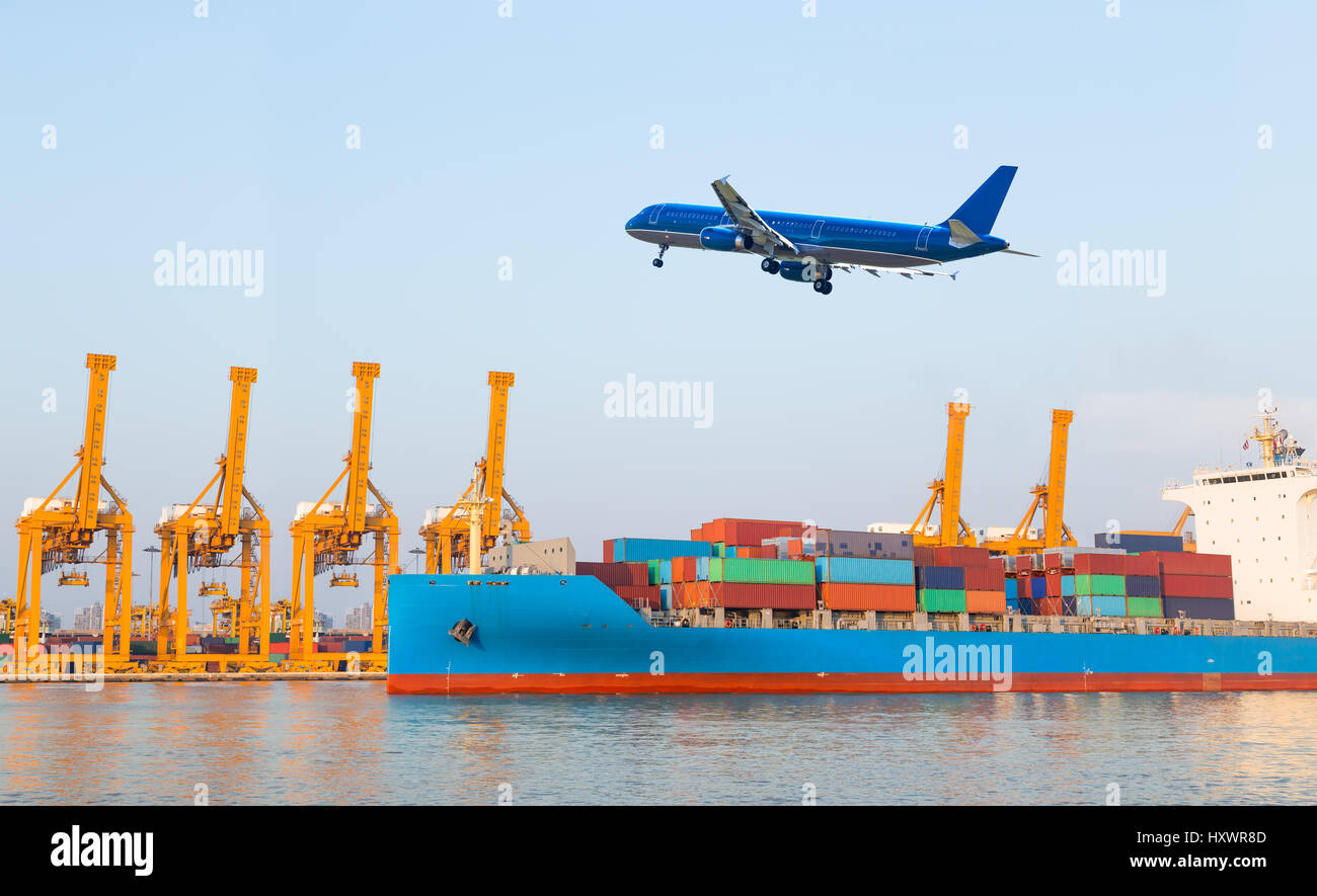 Container cargo freight ship with working crane loading bridge in ...