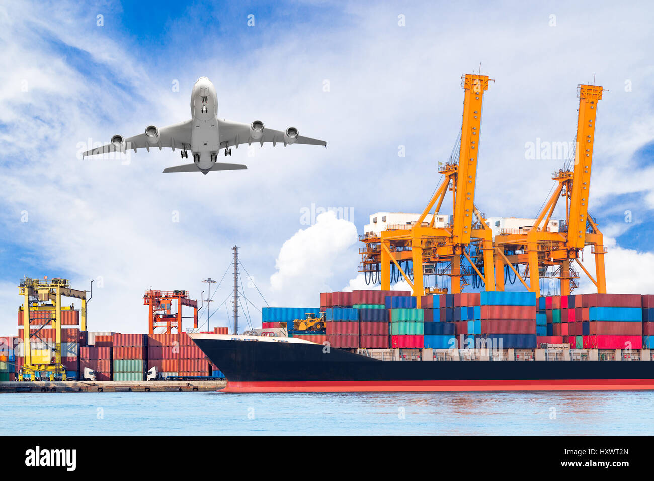 Container cargo freight ship with working crane loading bridge in ...