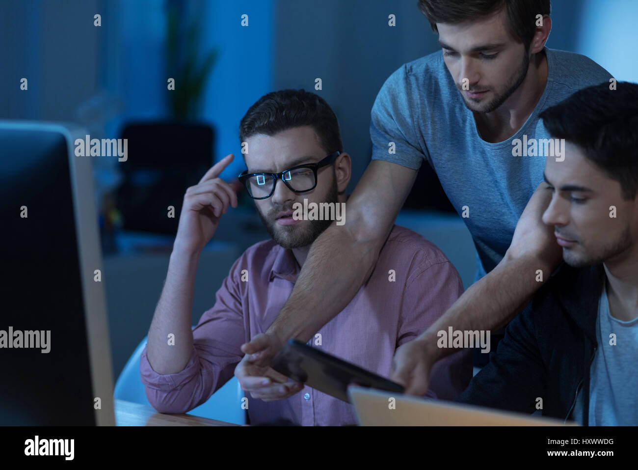 Serious bearded programmer holding a tablet Stock Photo - Alamy