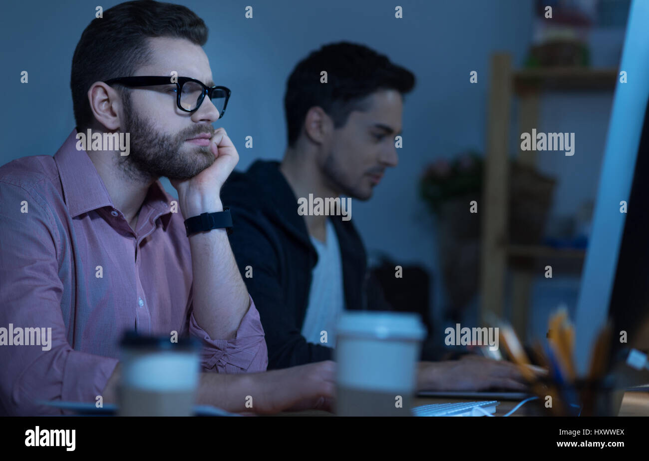 Handsome pensive programmer working on the computer Stock Photo - Alamy Handsome pensive programmer working on the computer Stock Photo - Alamy