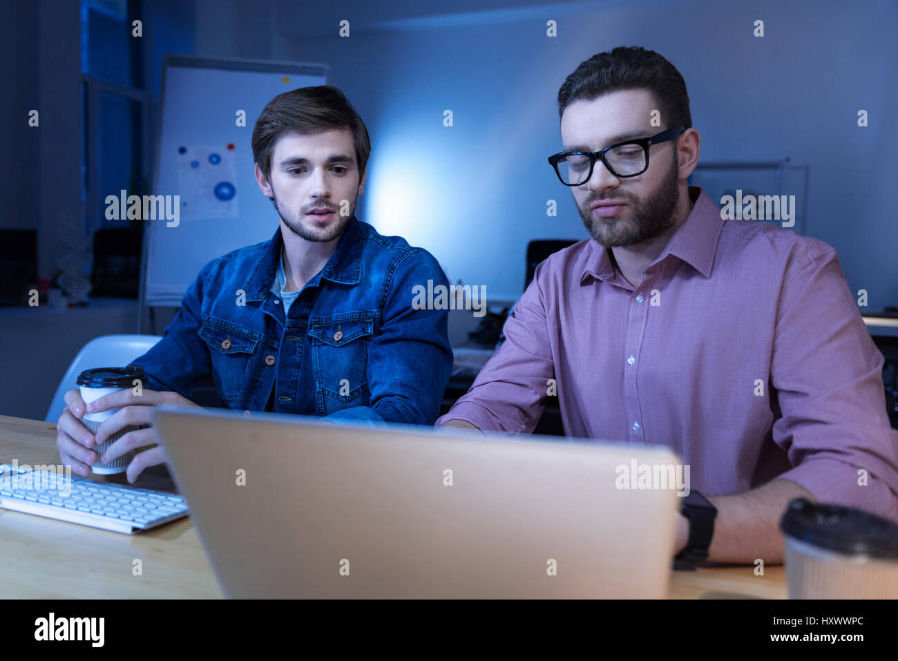 Nice brutal men using laptop Stock Photo - Alamy