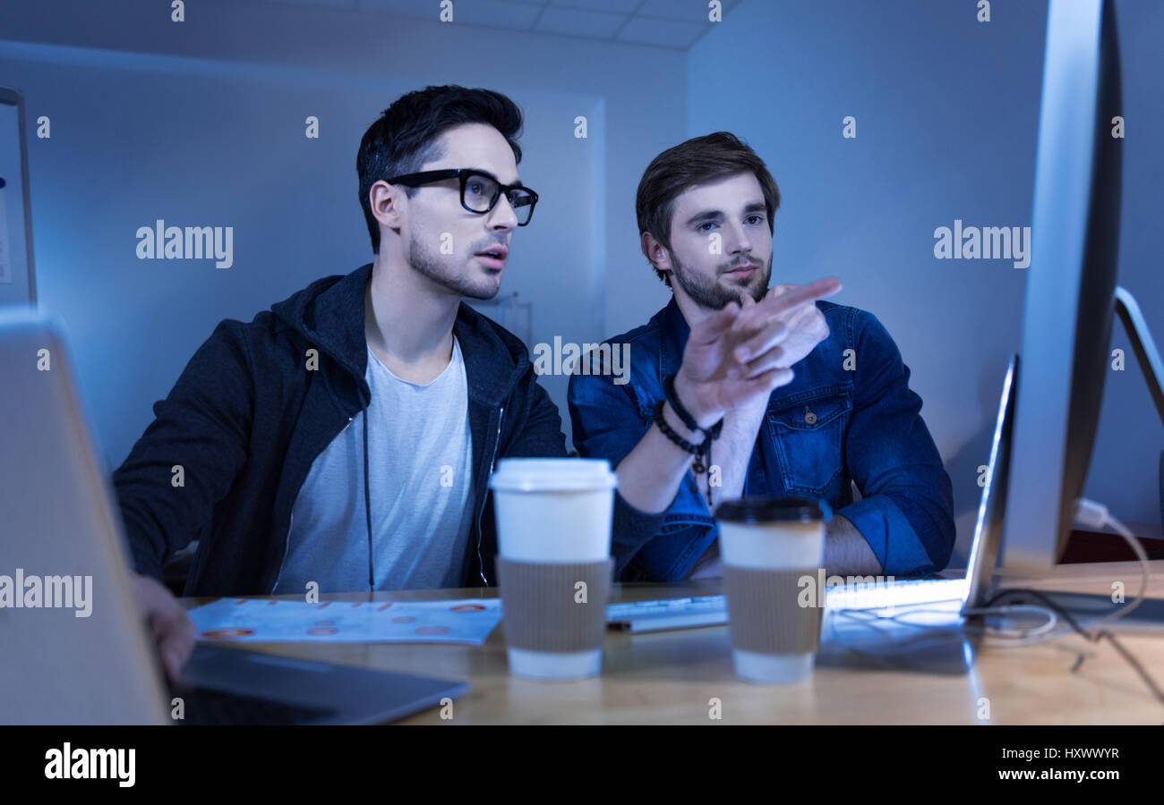 Smart intelligent hacker pointing at the computer screen Stock Photo ...