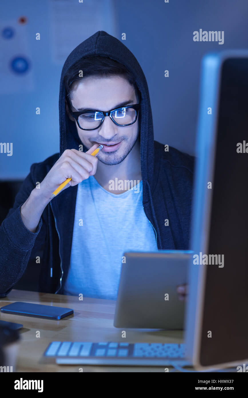 Handsome nice programmer biting the pencil Stock Photo - Alamy