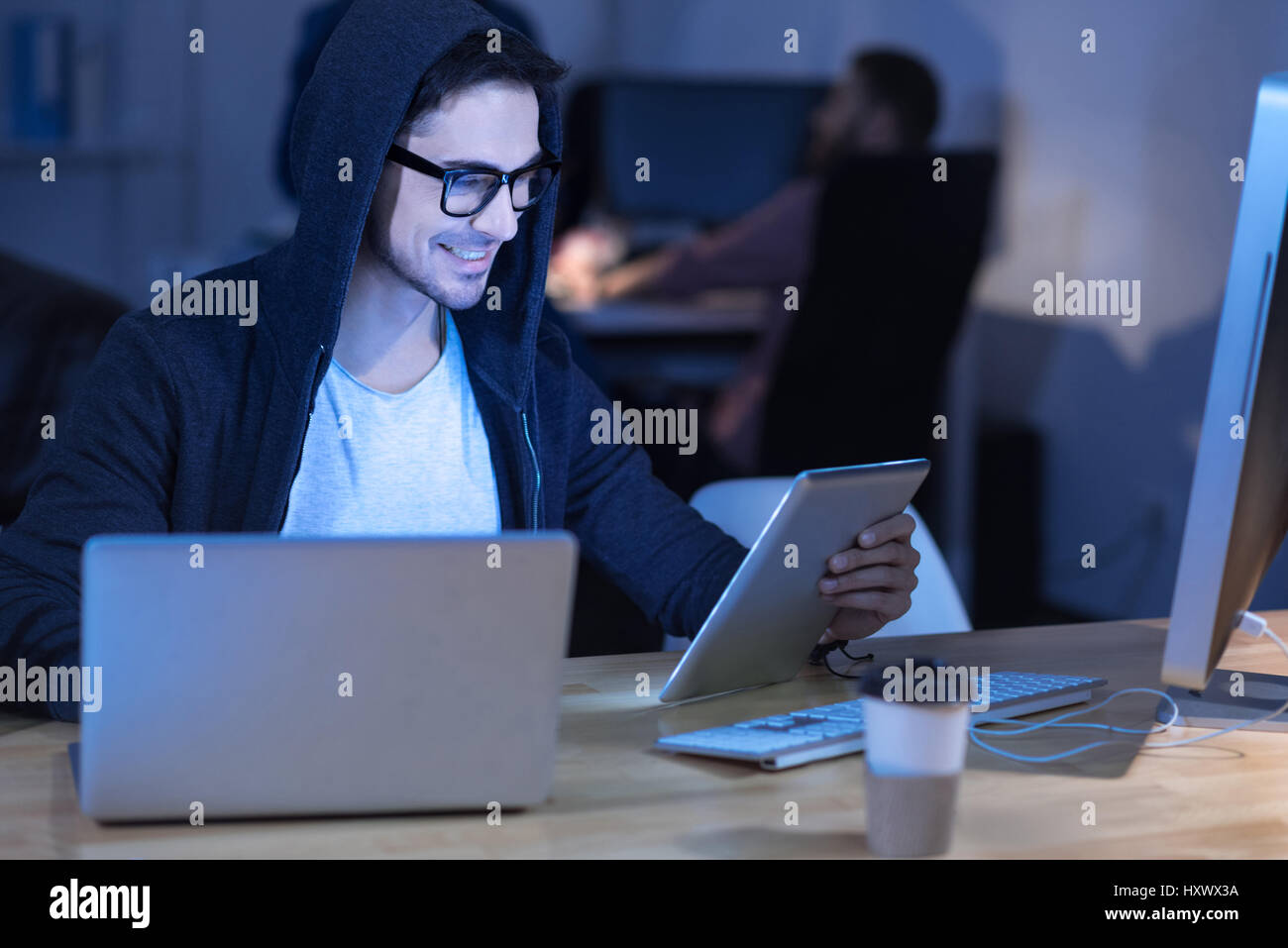Delighted genius hacker being surrounded by modern technology Stock ...