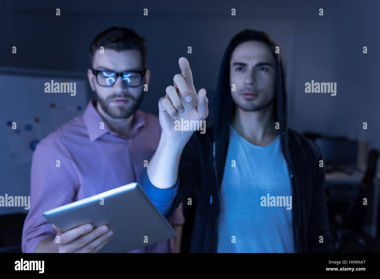 Thoughtful handsome man touching the screen Stock Photo - Alamy