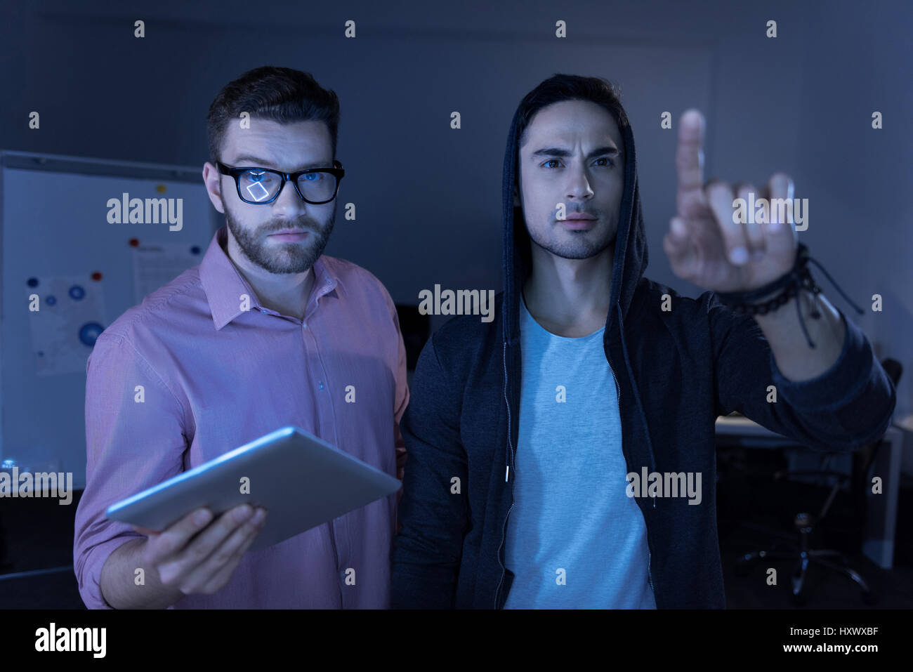 Smart professional IT men working with innovative technologies Stock ...