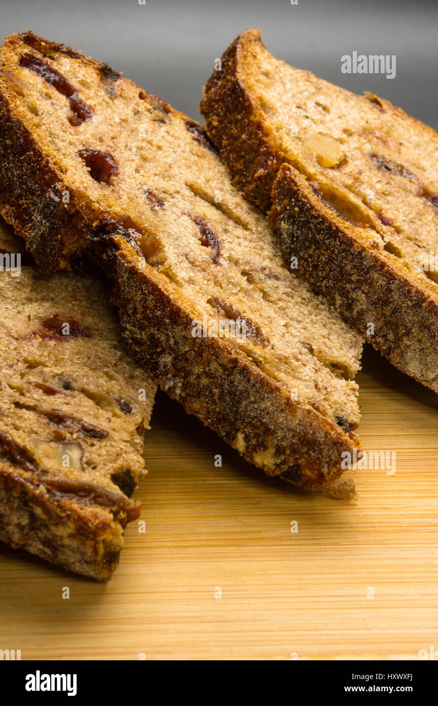 Slices of malt bread handmade with nuts, raisins and cranberries on ...