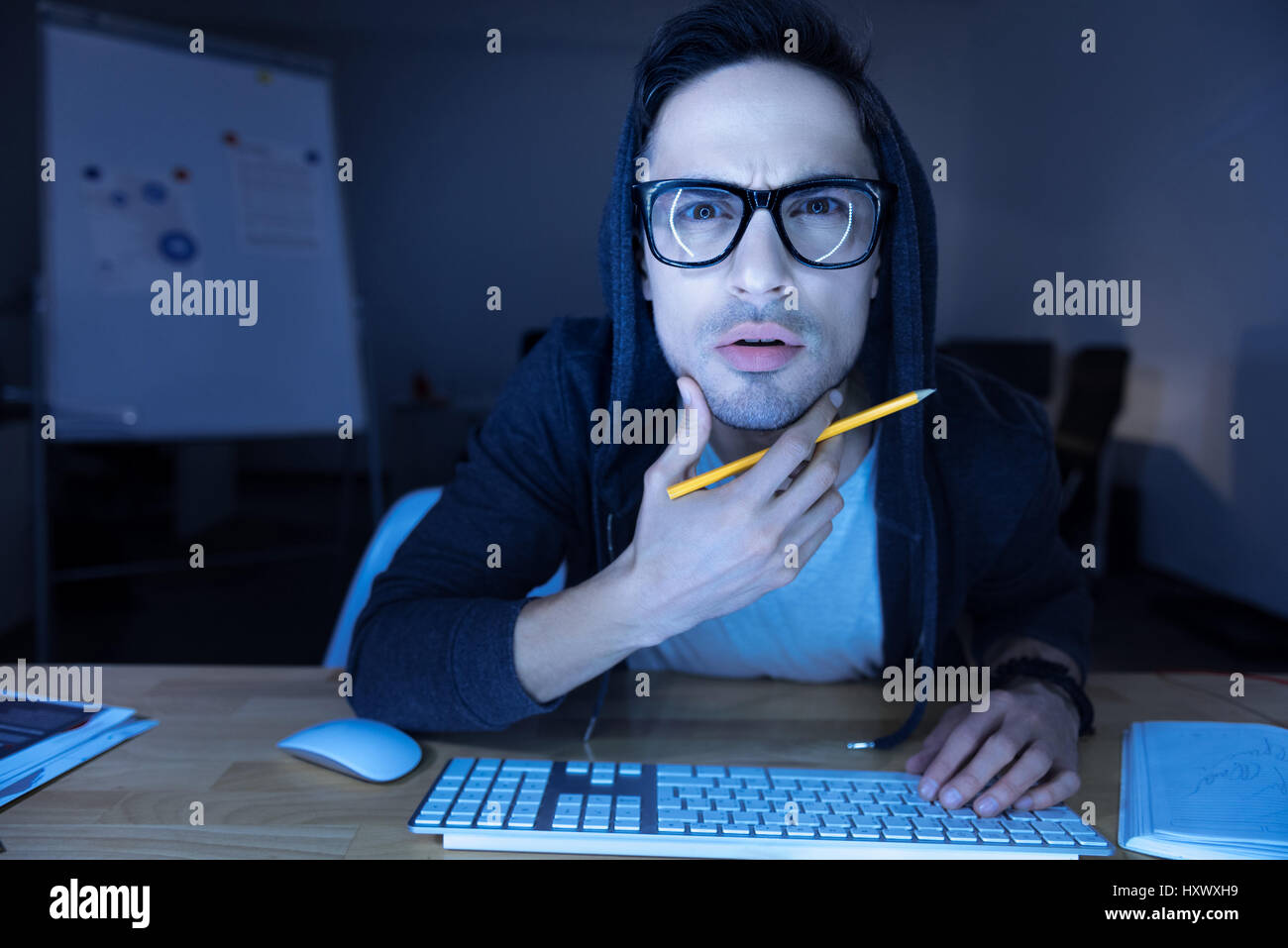 Handsome serious man holding his chin Stock Photo - Alamy