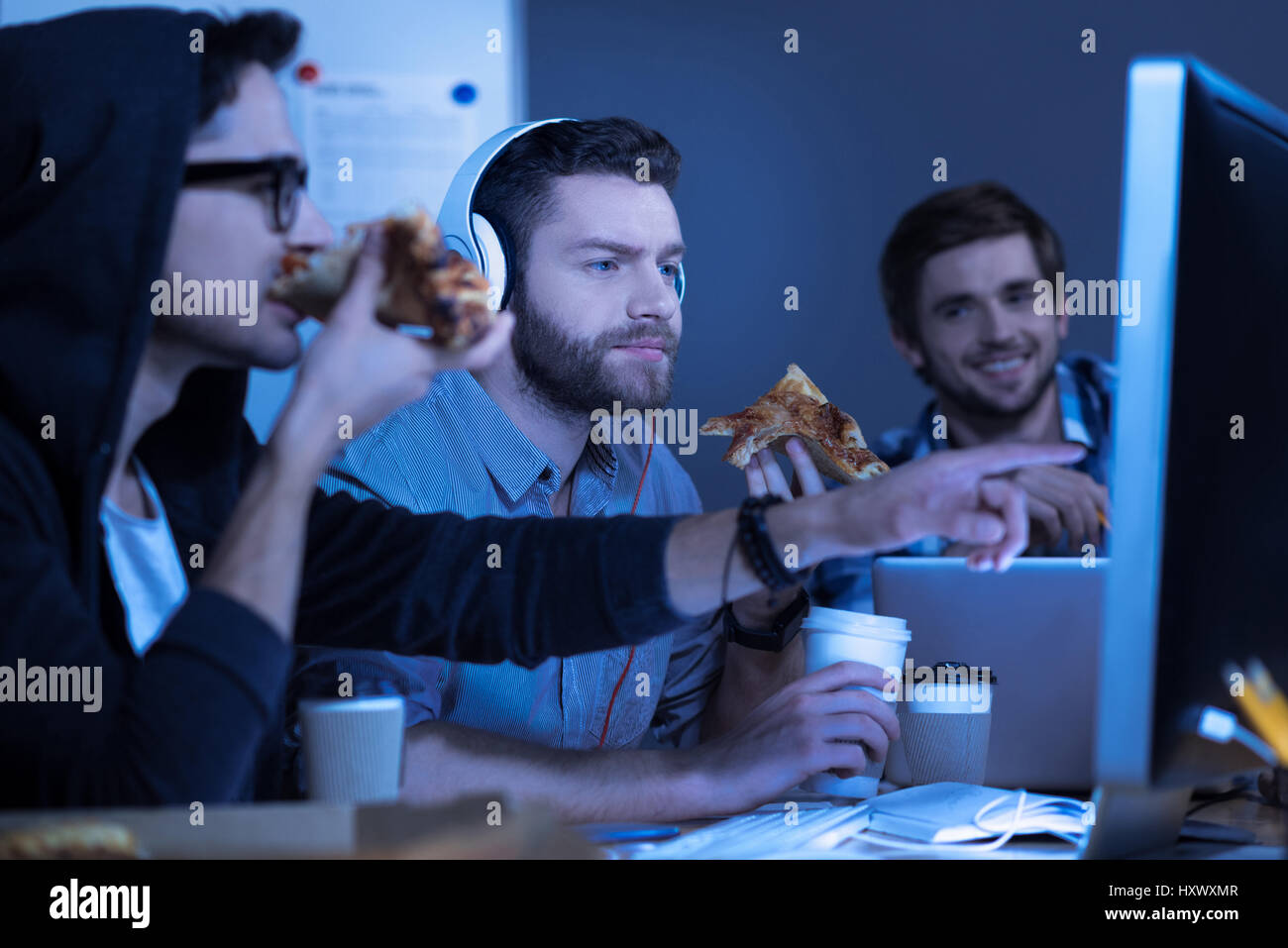 Nice pleasant man pointing at the screen Stock Photo - Alamy