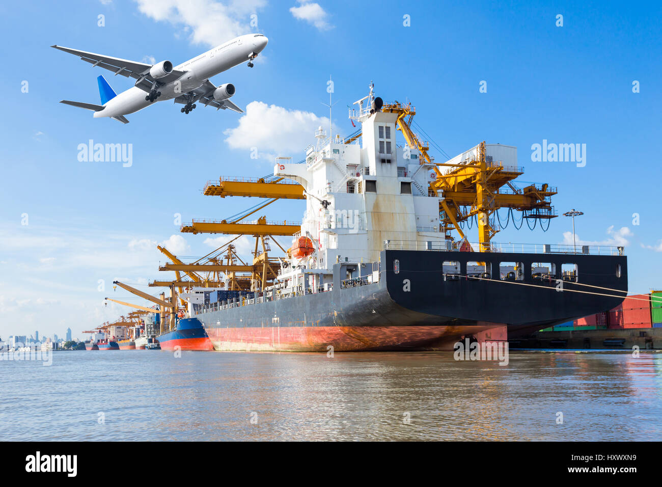 Cargo plane flying above ship port for logistic import export ...