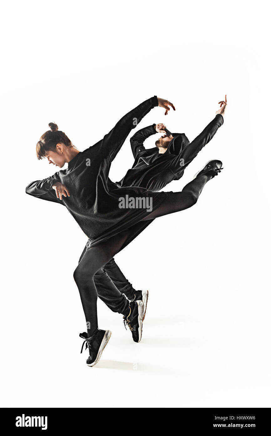 The silhouettes of two hip hop male and female break dancers dancing on ...