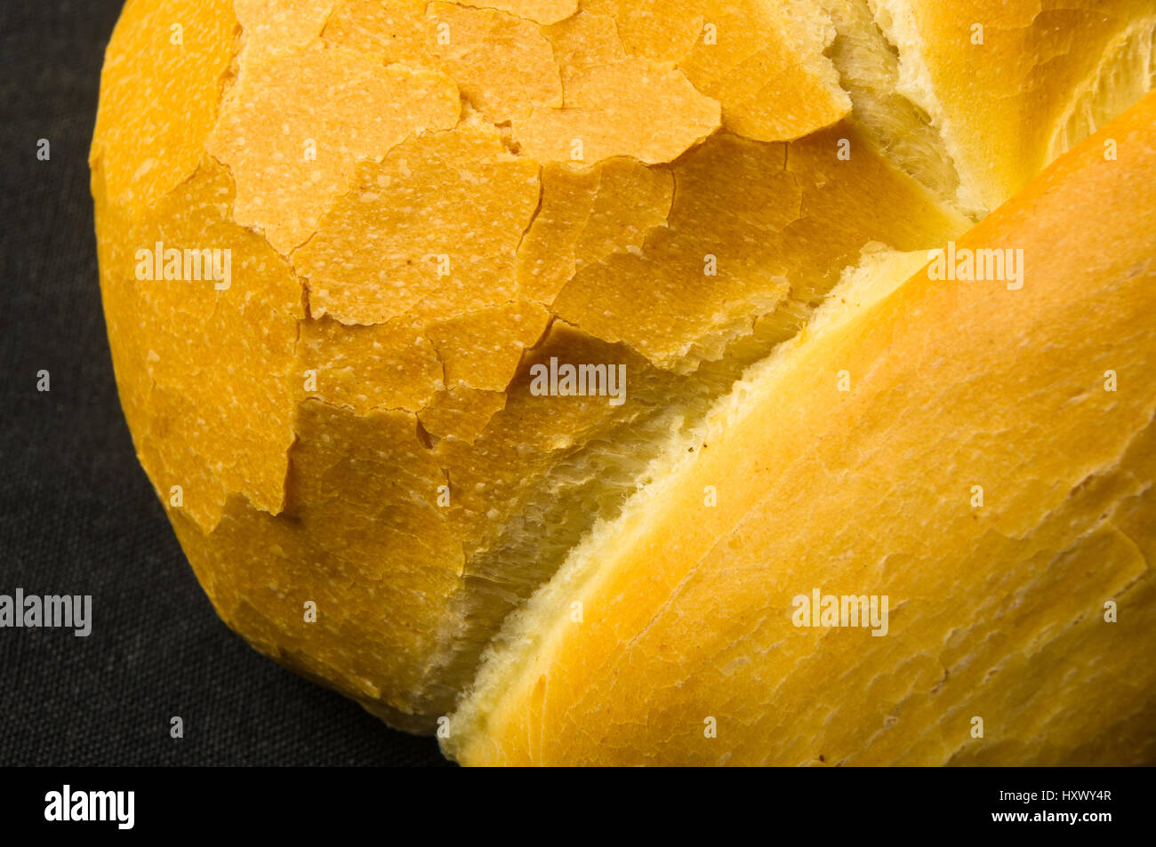 fresh braided loaf of white wheat bread on black background Stock Photo ...
