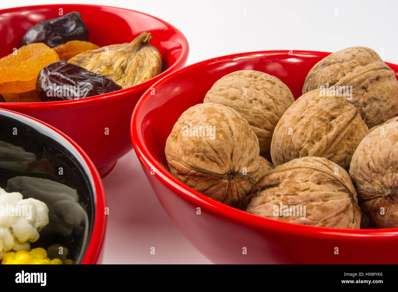 various dried fruits, mixed nuts and walnuts on the white background ...