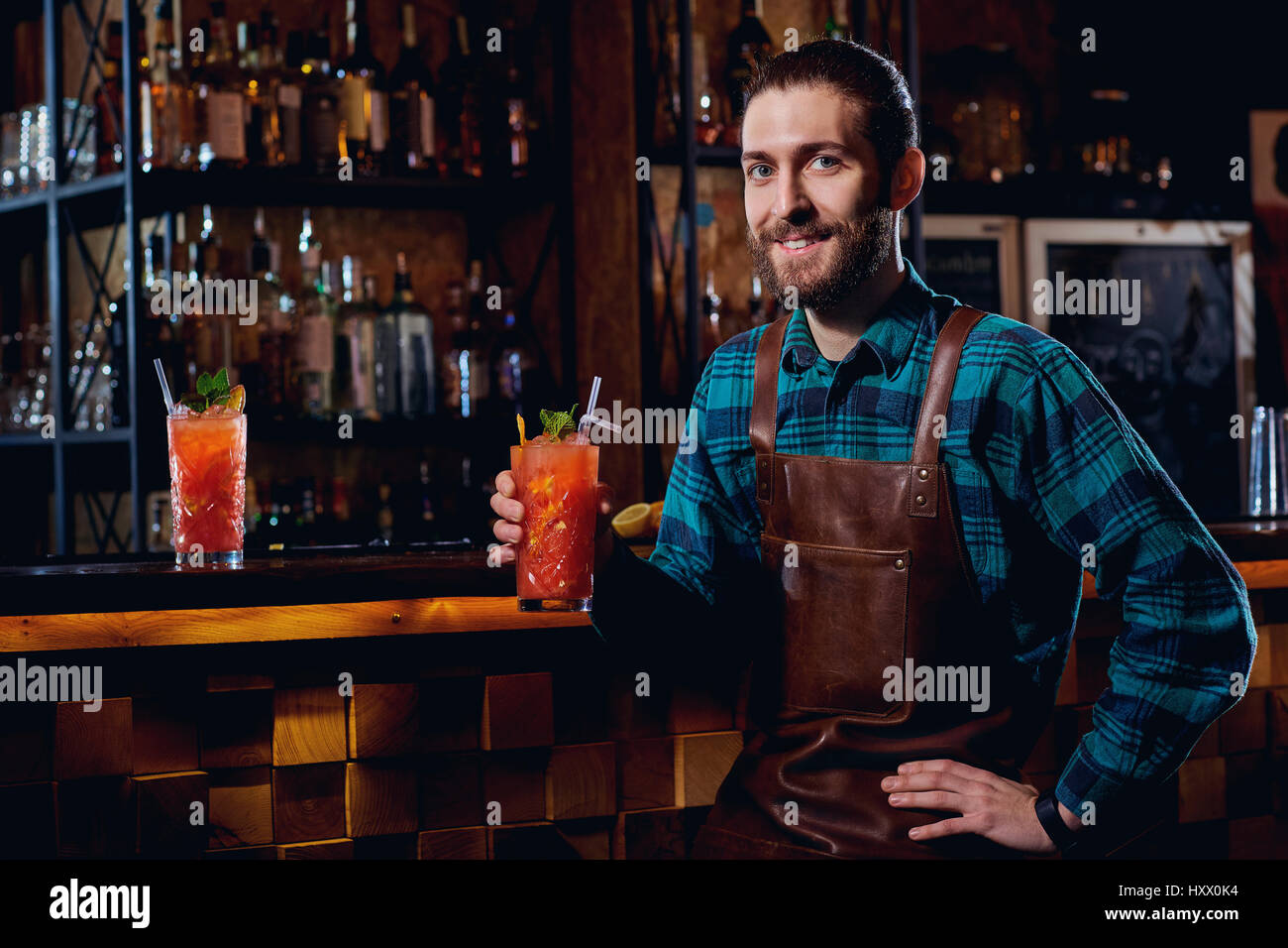 Portrait of a barman hipster with beard smiling sitting in bar Stock ...