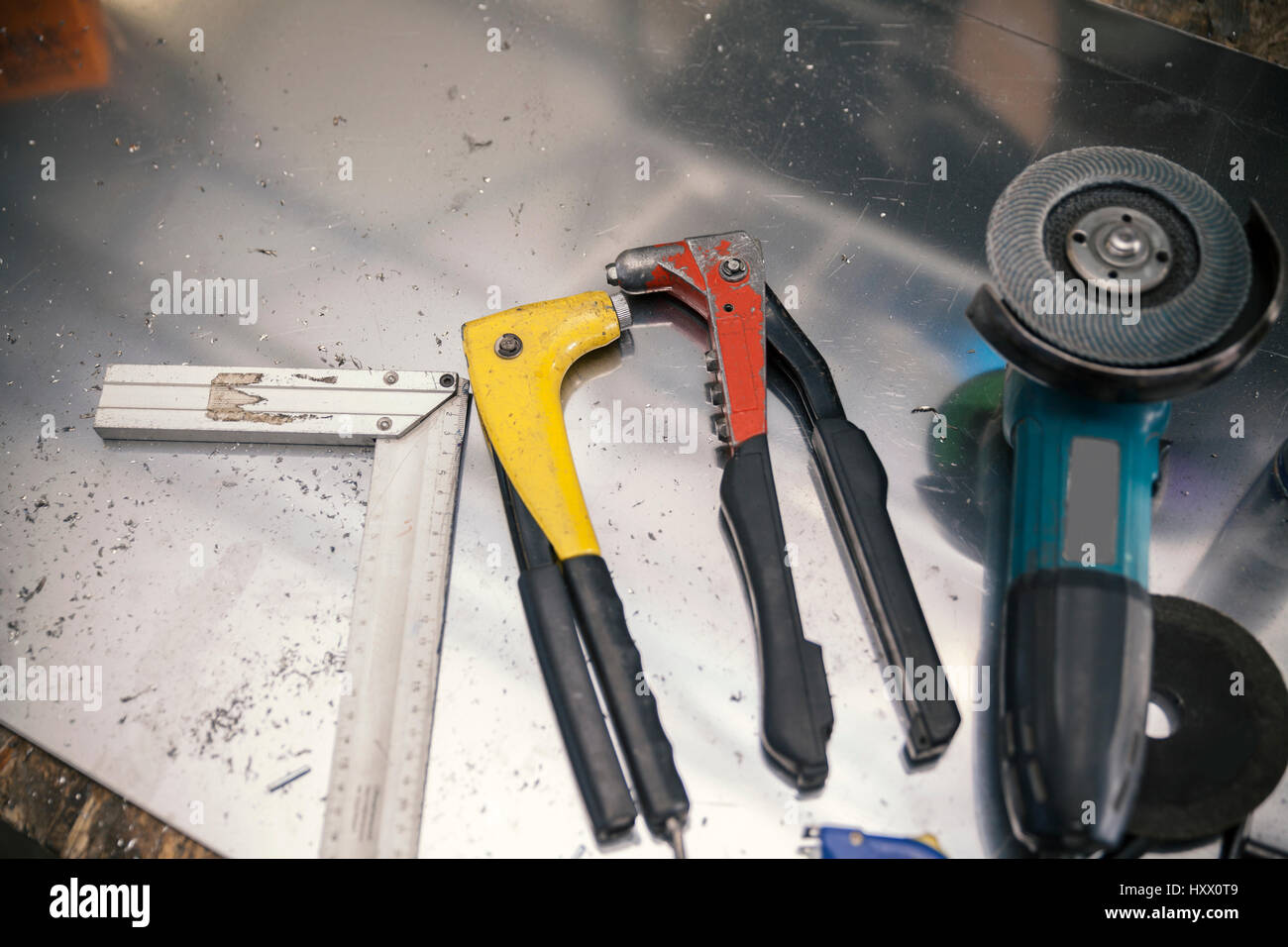 Hand tools and grinder on metal table Stock Photo - Alamy