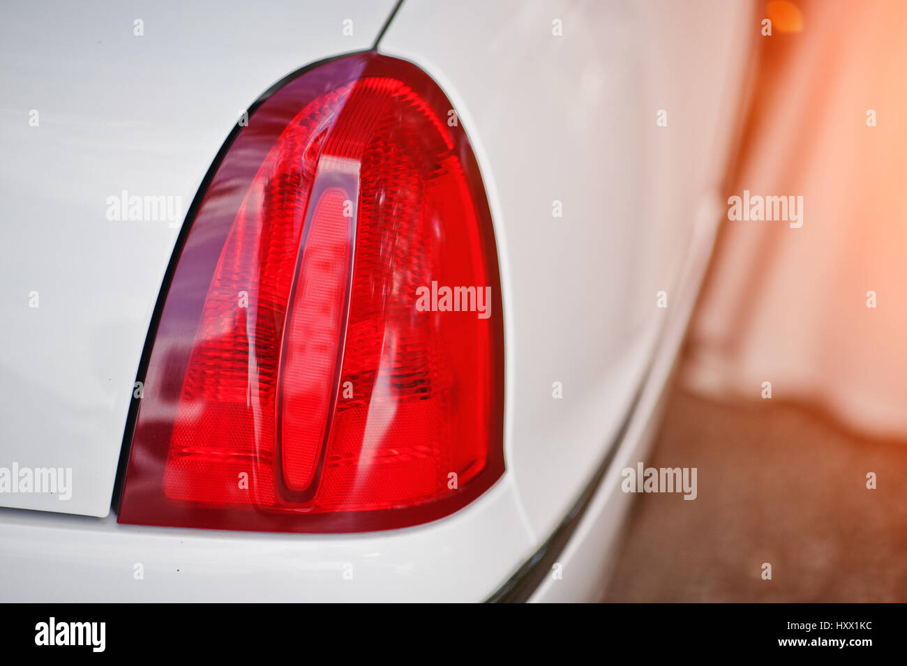 Red back headlight of white luxury limousine car Stock Photo - Alamy