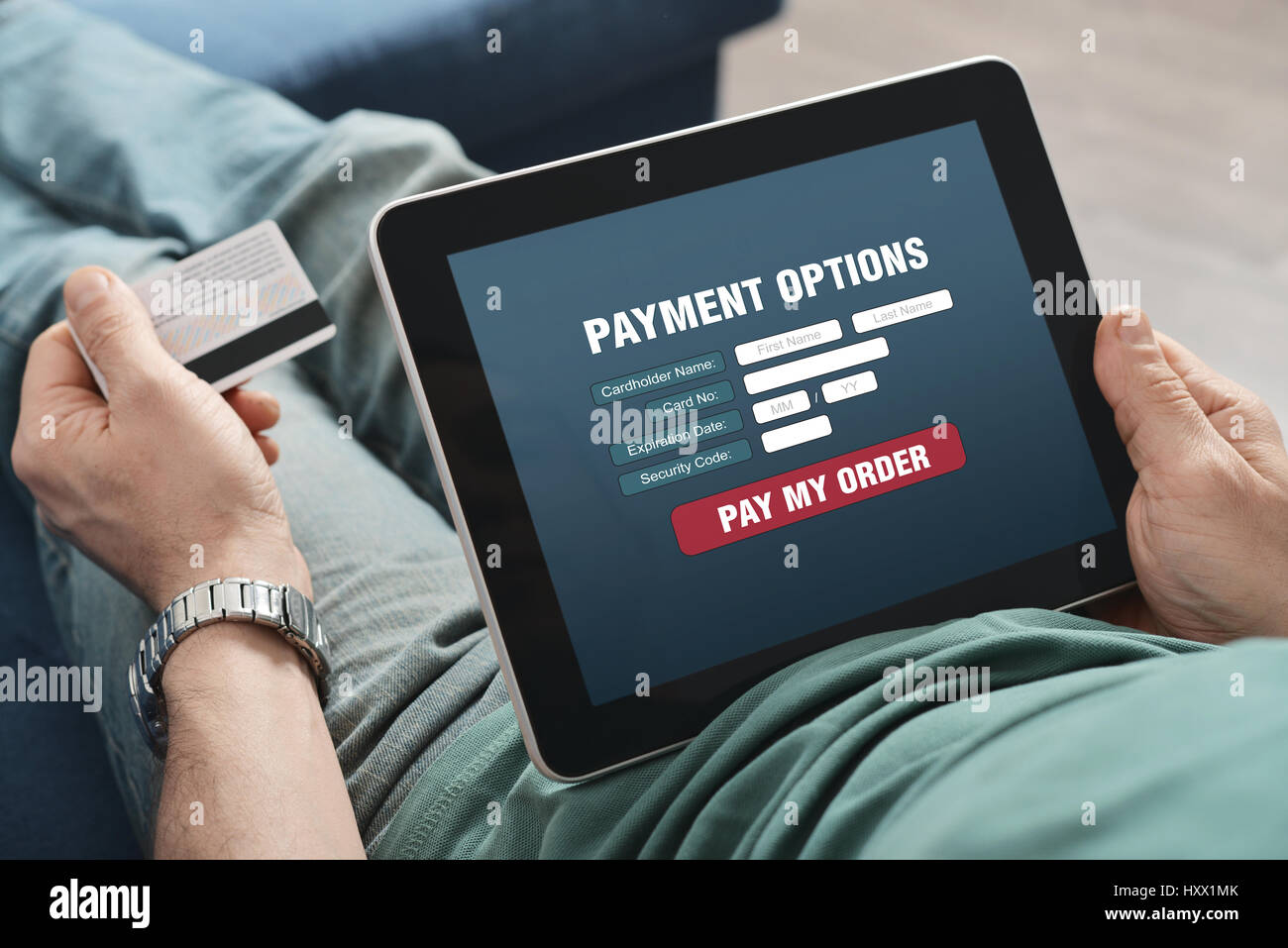 Male hands using touch screen device for online payment Stock Photo - Alamy