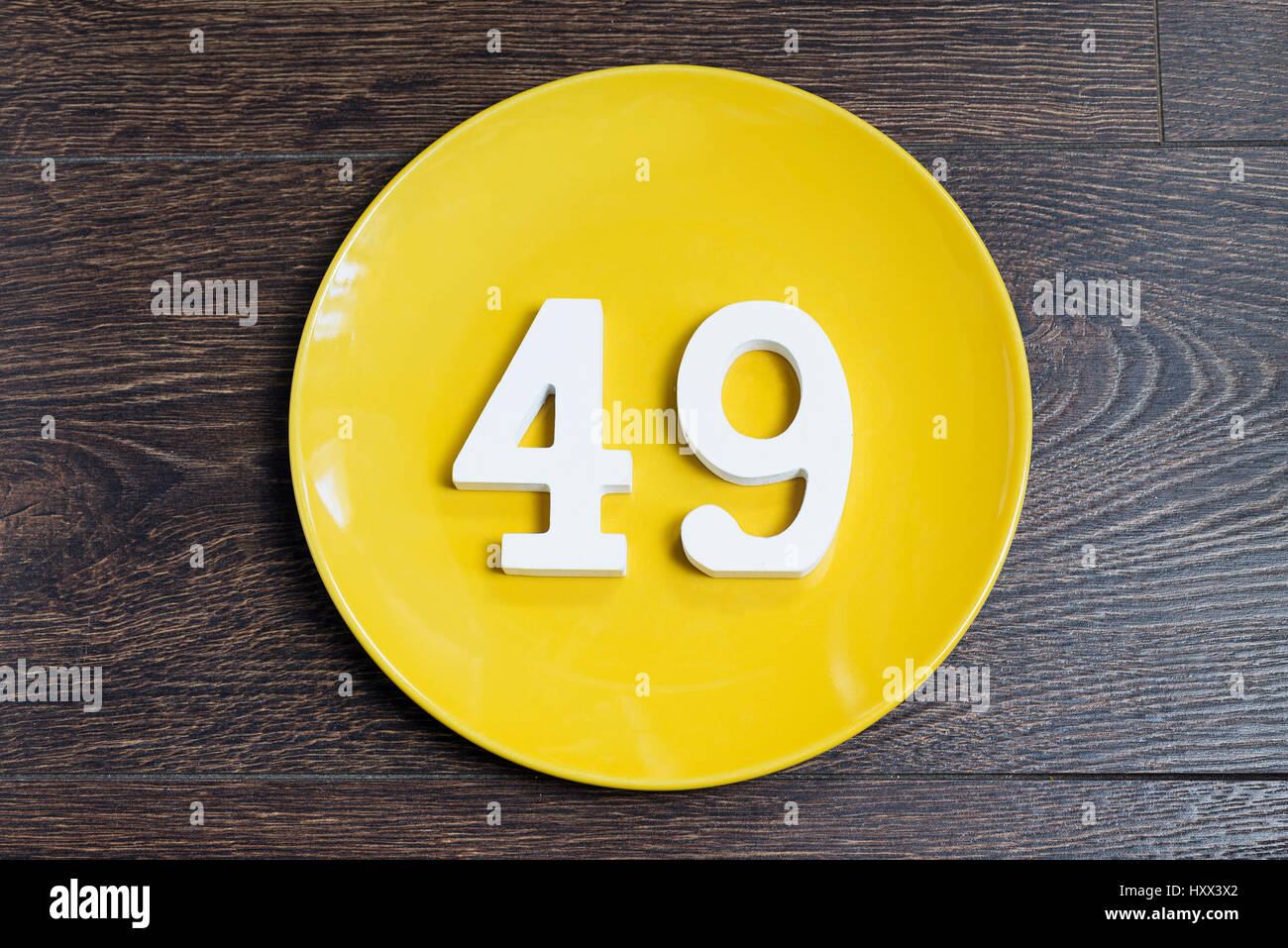 Number forty nine on the yellow plate and brown background Stock Photo ...
